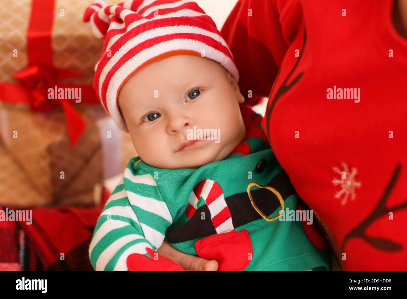 Mother with cute little baby in elf's costume at home Stock Photo - Alamy