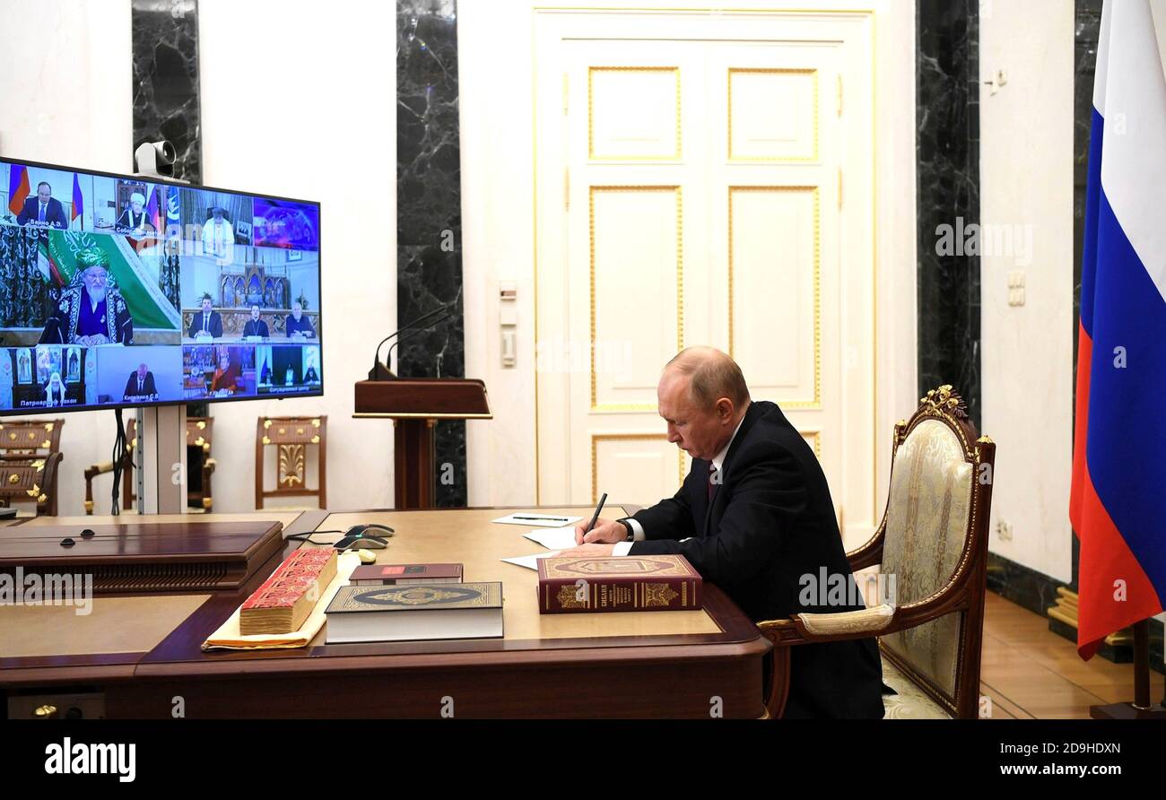 Russian President Vladimir Putin, holds a video conference with ...