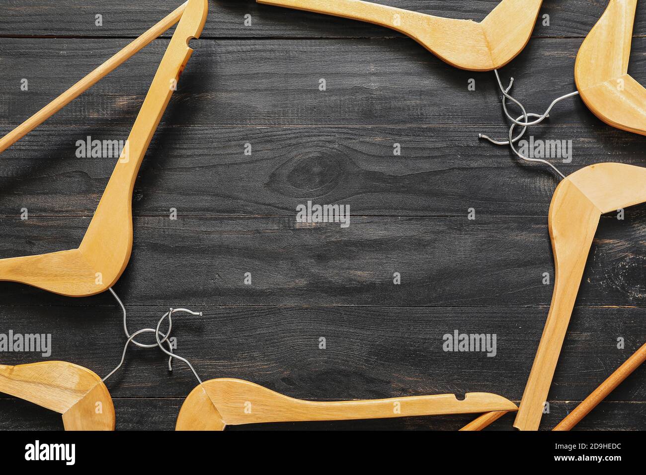Clothes hangers on dark background Stock Photo - Alamy