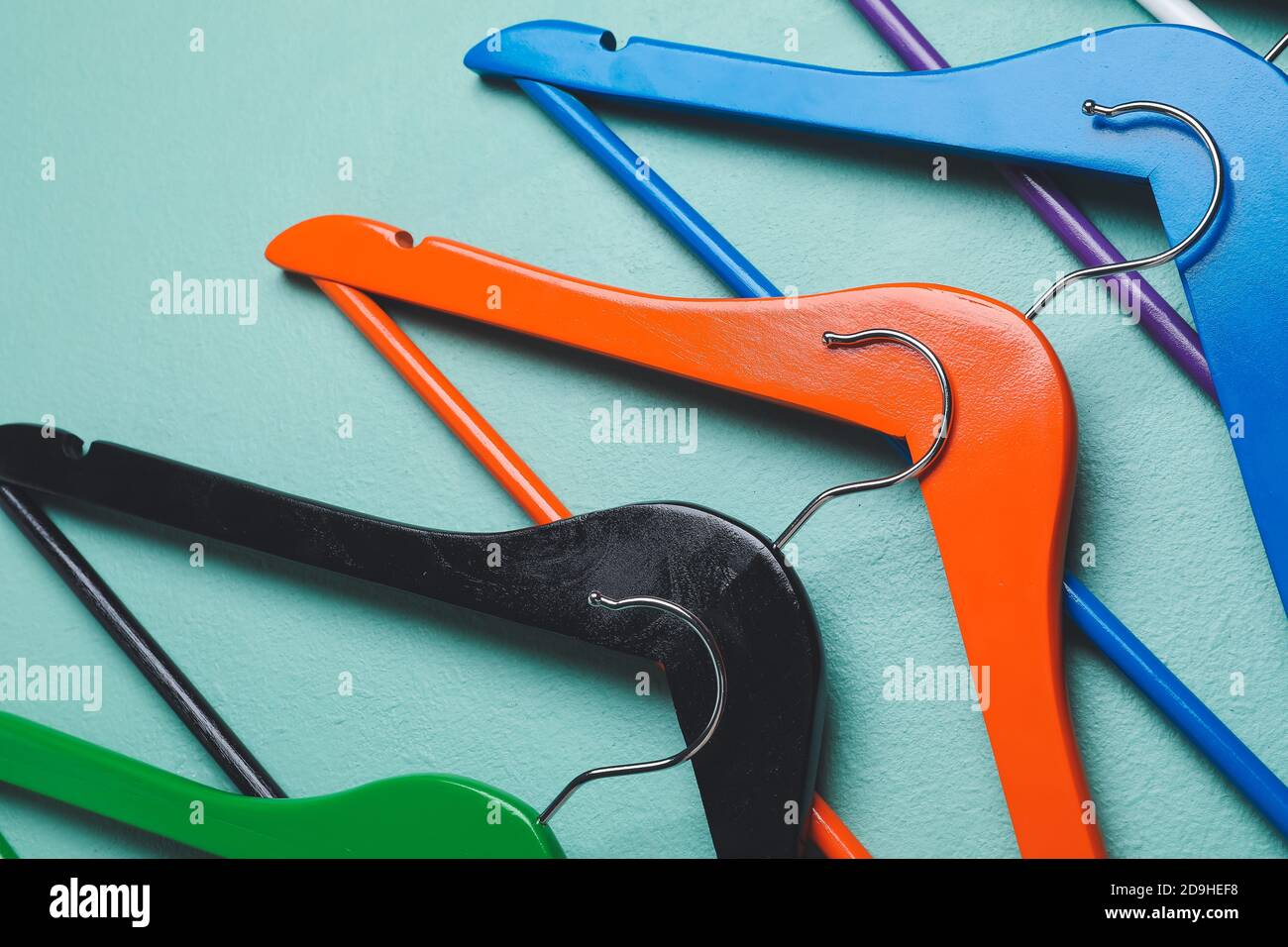 Clothes hangers on color background Stock Photo - Alamy