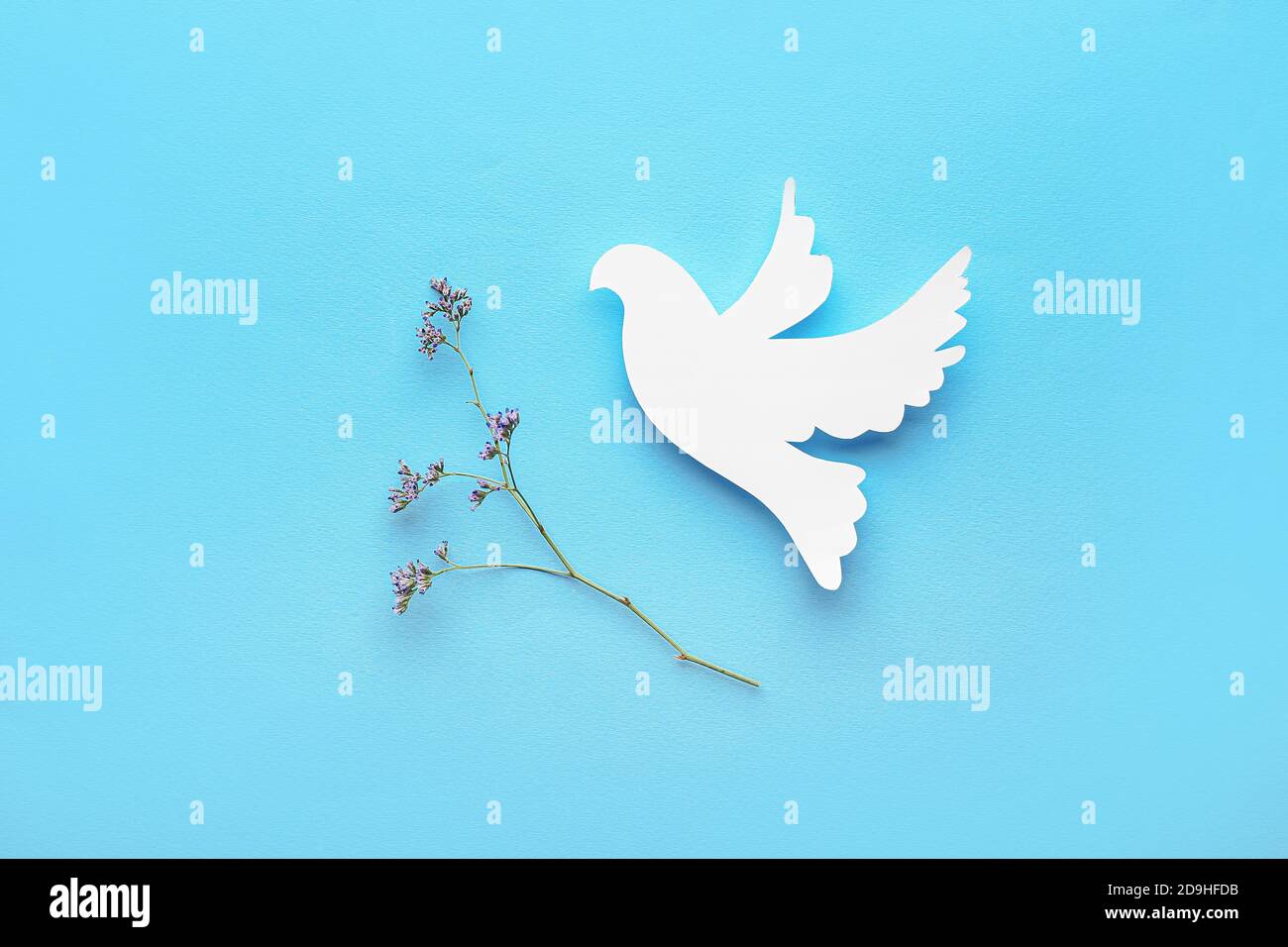 Paper dove on color background. International Day of Peace Stock Photo ...