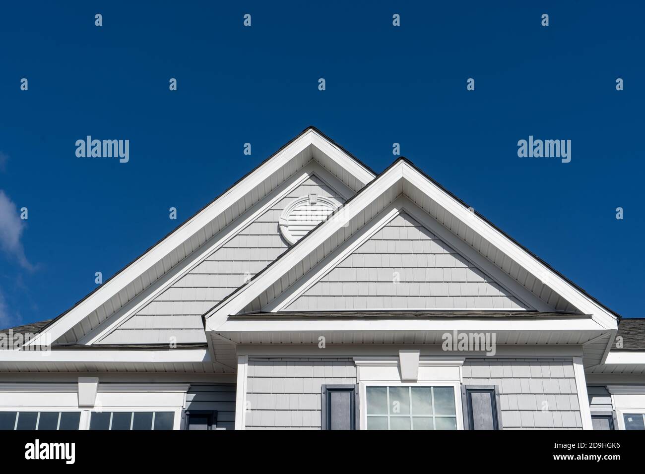 Double gable roof with attic vent or window Stock Photo - Alamy