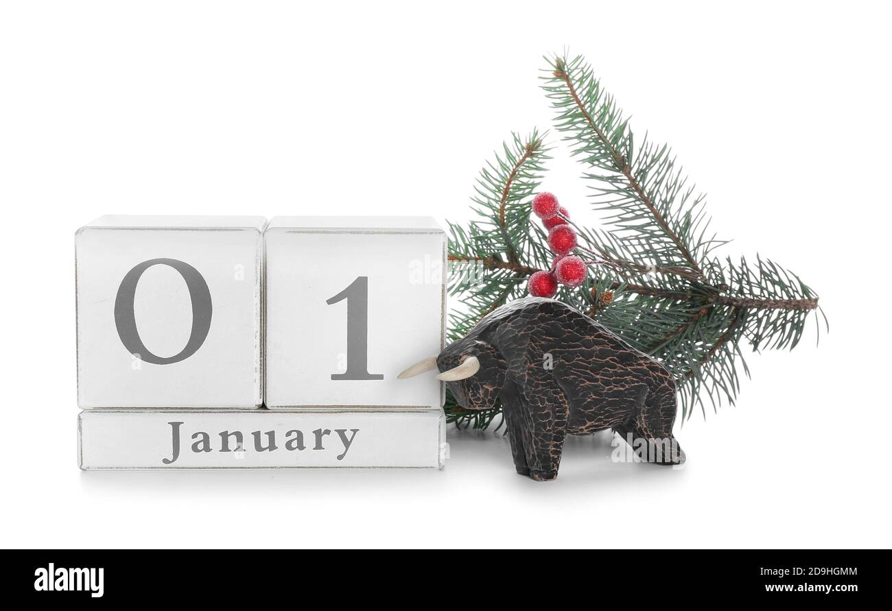 Figurine of bull, calendar and New Year decor on white background Stock ...