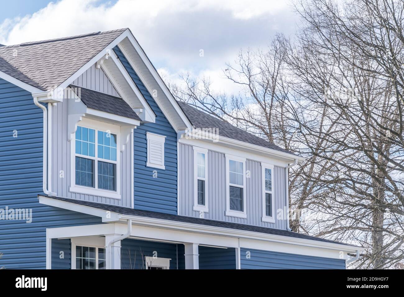 Decorative double gable with blue horizontal siding on a house Stock ...