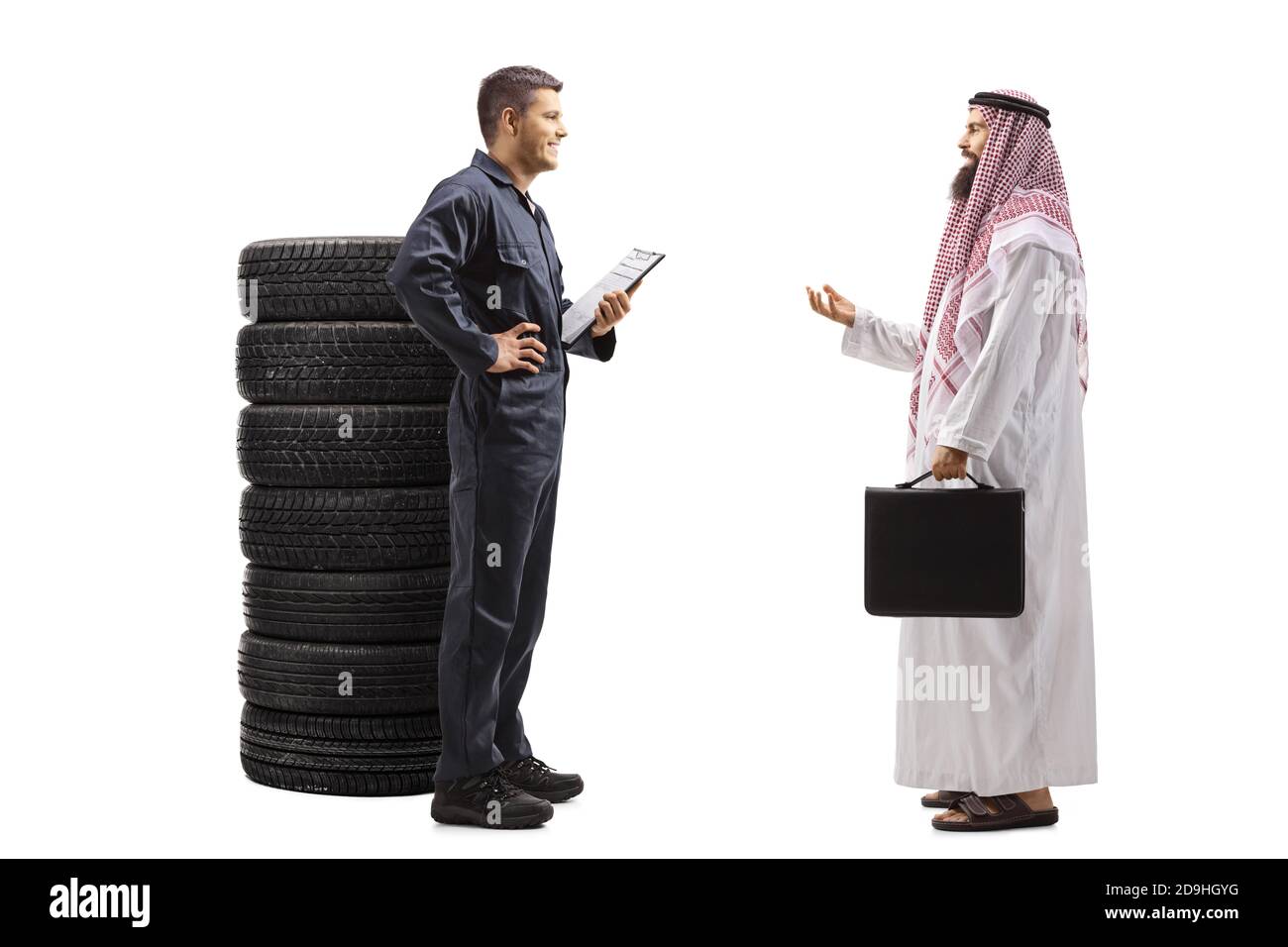 Full length profile shot of an auto mechanic and a male arab customer ...