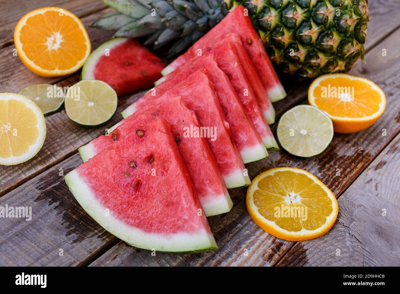 Top view of sliced fresh tropical fruits on a wooden surface Stock ...