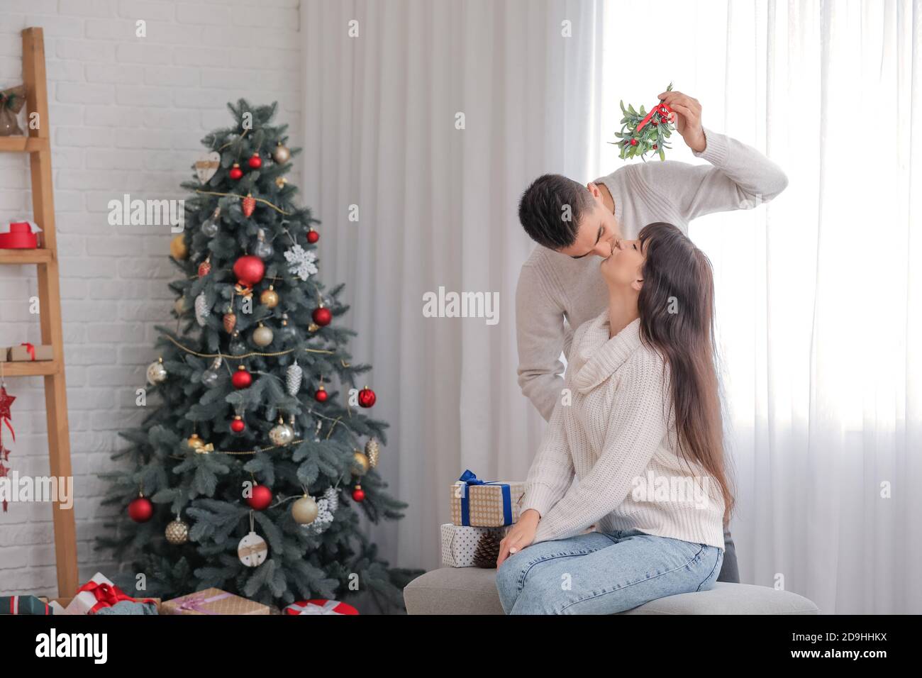 Kissing under the mistletoe portrait hi-res stock photography and ...
