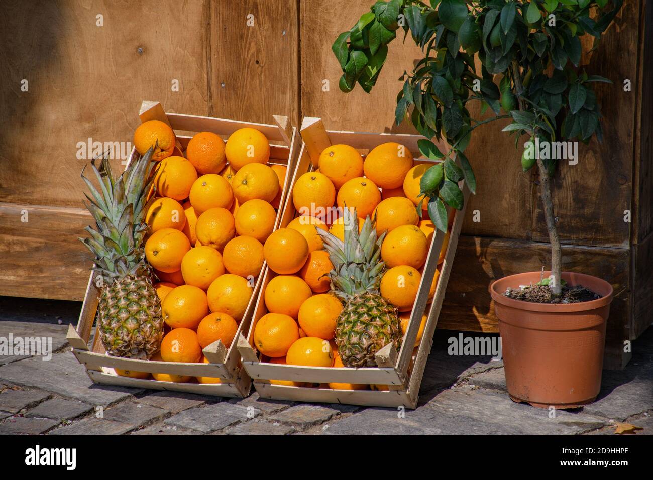 Wooden fruit boxes with fresh oranges and pineapples Stock Photo - Alamy