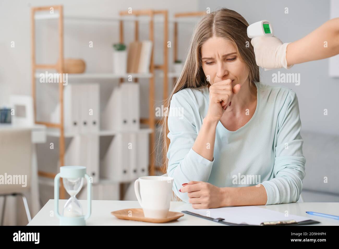 Measuring of woman's temperature in office. Coronavirus epidemic Stock ...