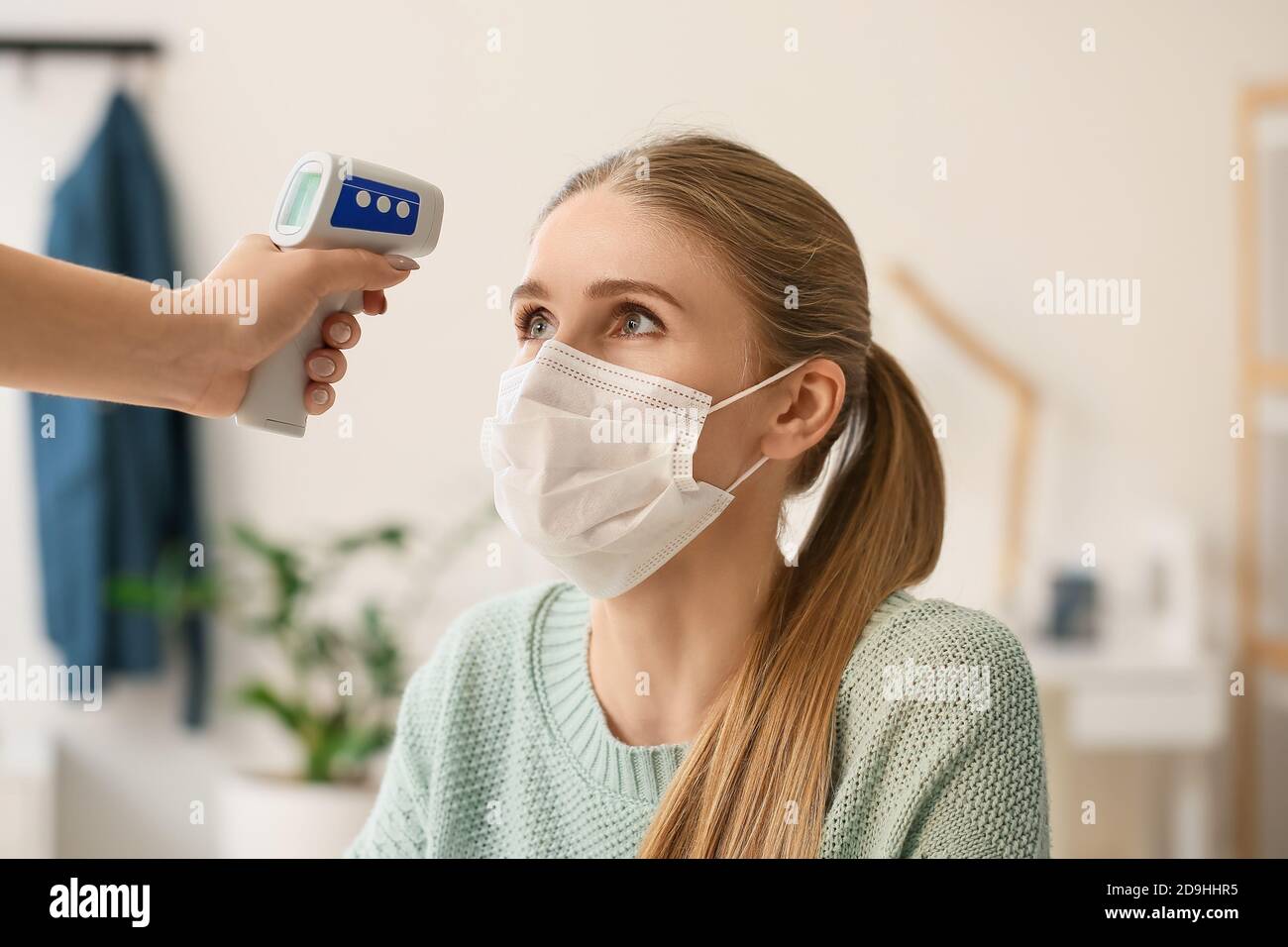 Measuring of woman's temperature in office. Coronavirus epidemic Stock ...