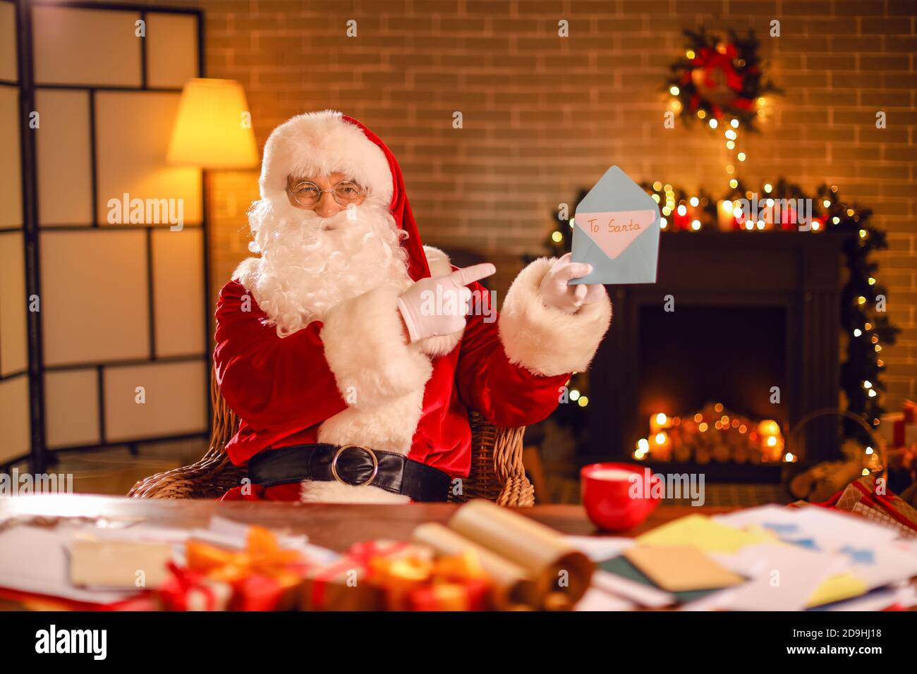 Santa Claus reading letters at home on Christmas eve Stock Photo - Alamy