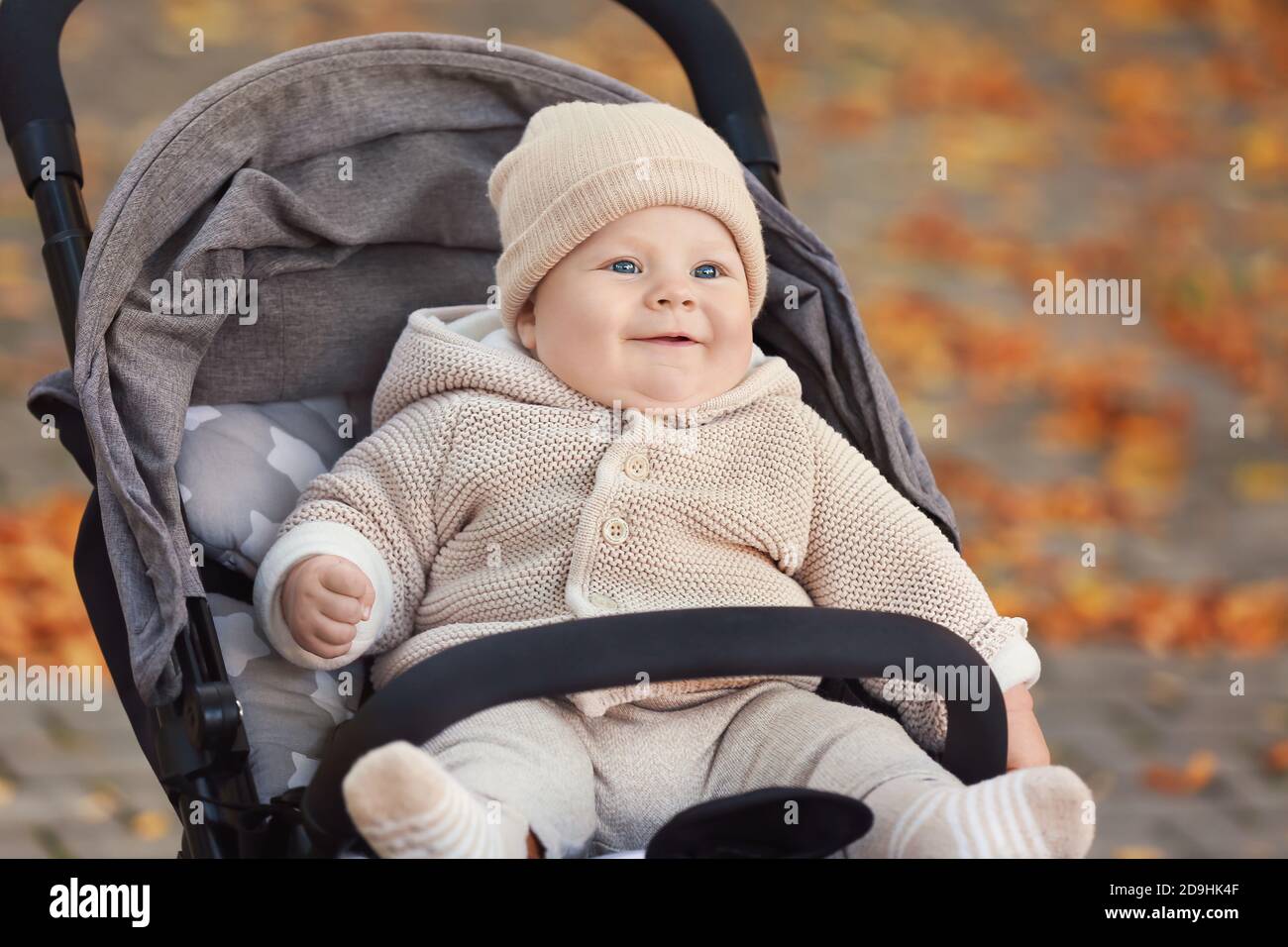Cute funny baby in stroller outdoors Stock Photo - Alamy