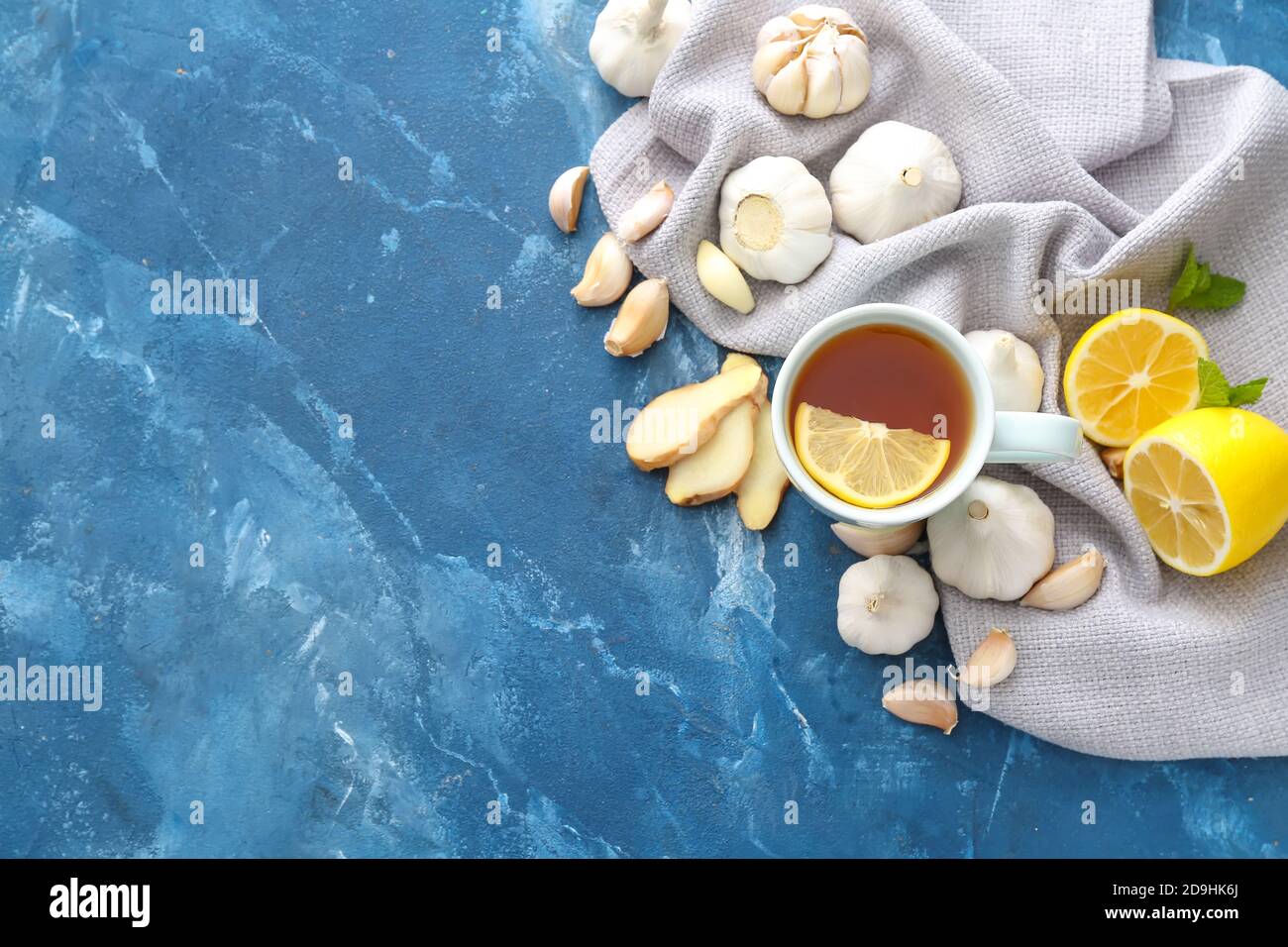 Cup of healthy garlic tea on color background Stock Photo - Alamy