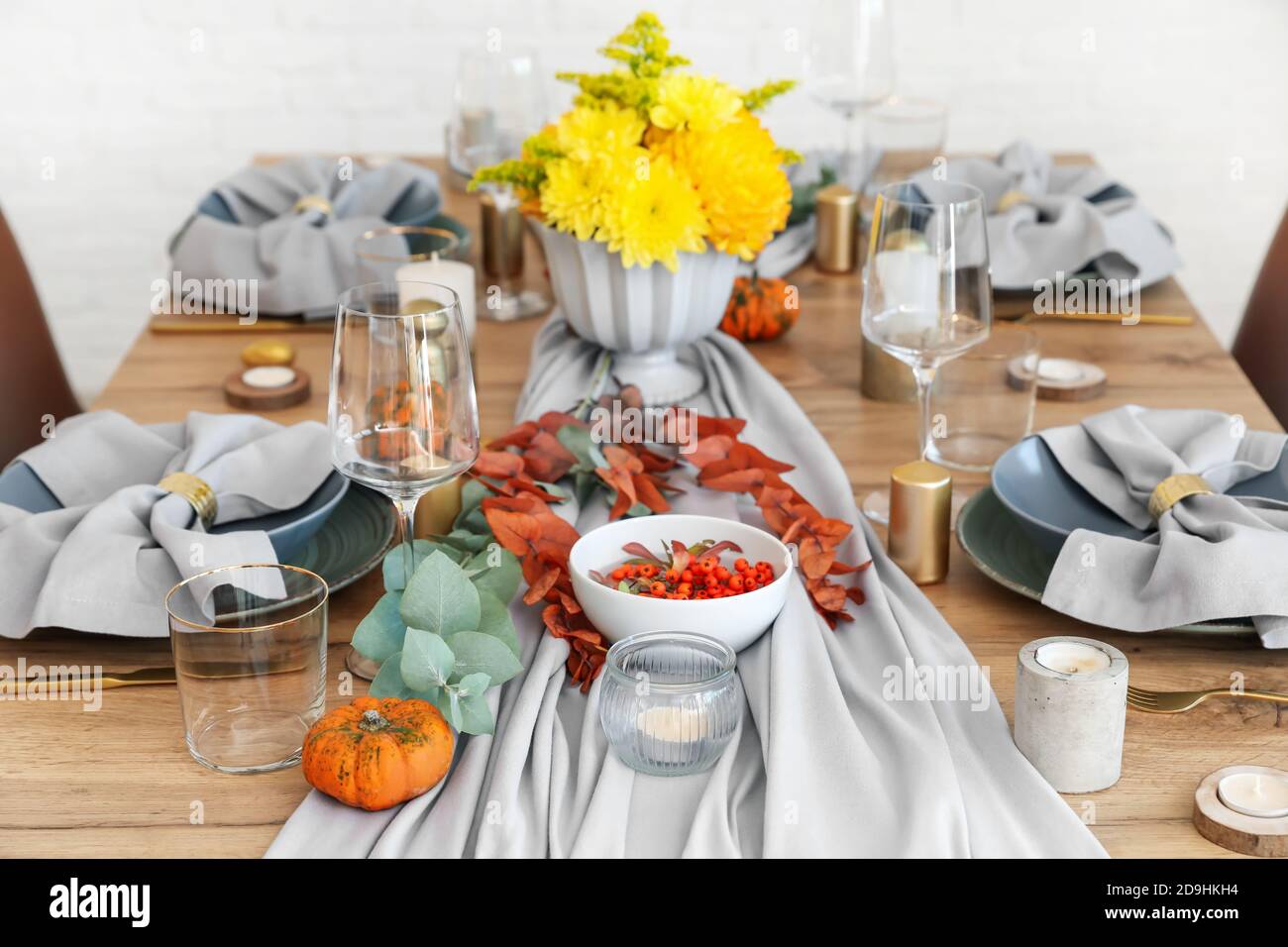 Beautiful table setting with pumpkins and autumn leaves in dining room ...