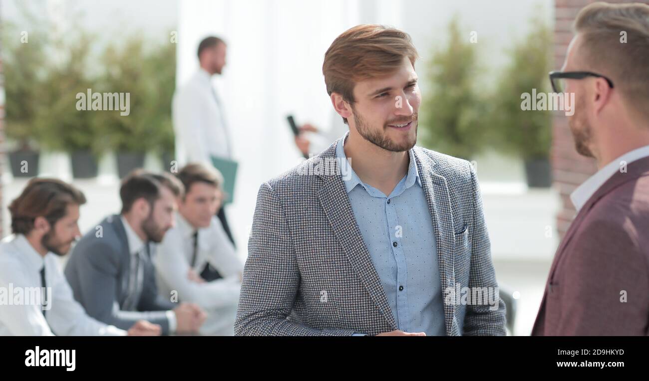 two business men talking standing in the office Stock Photo - Alamy
