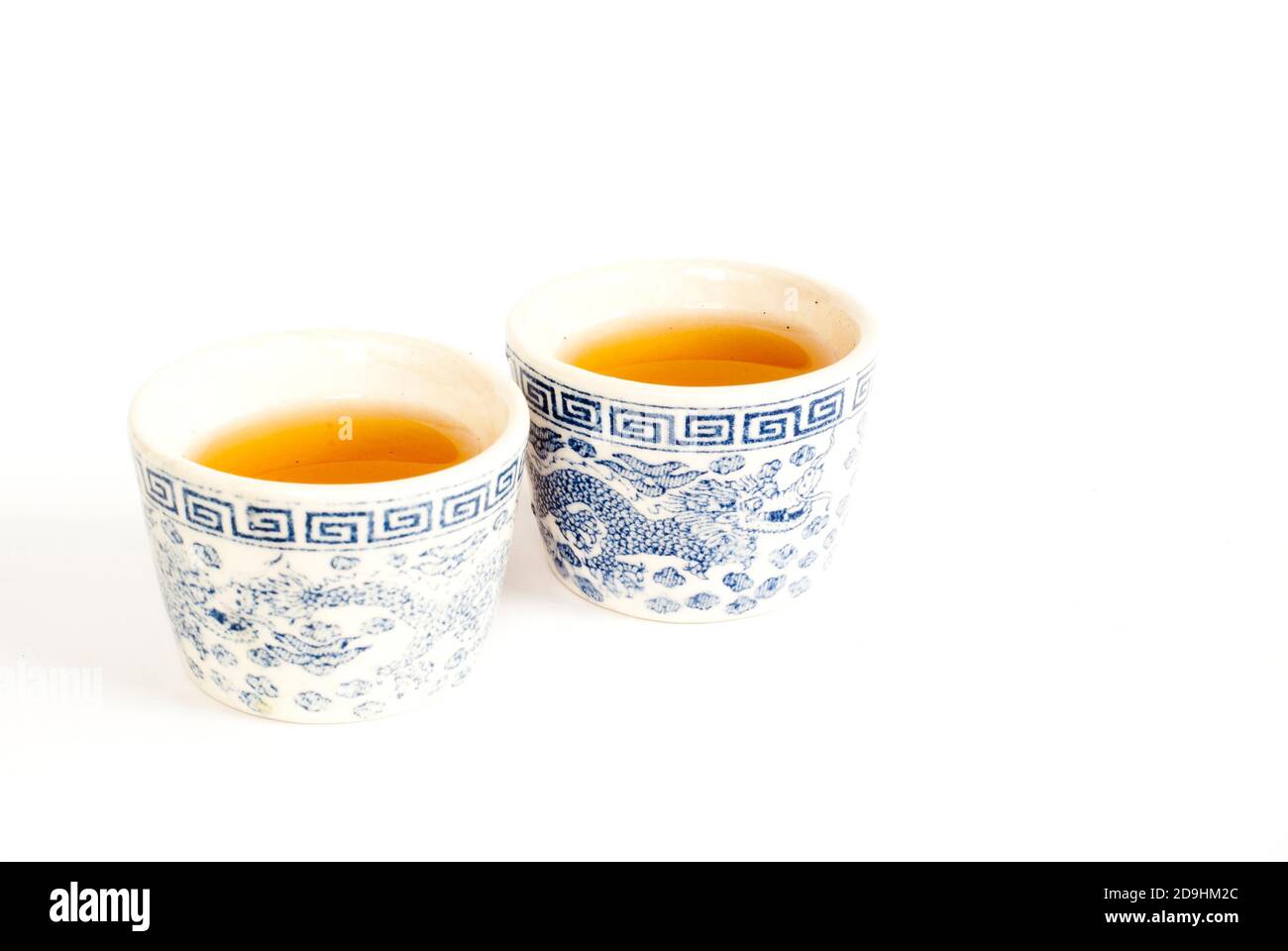 Dragon pattern on Chinese tea cups on white background Stock Photo - Alamy