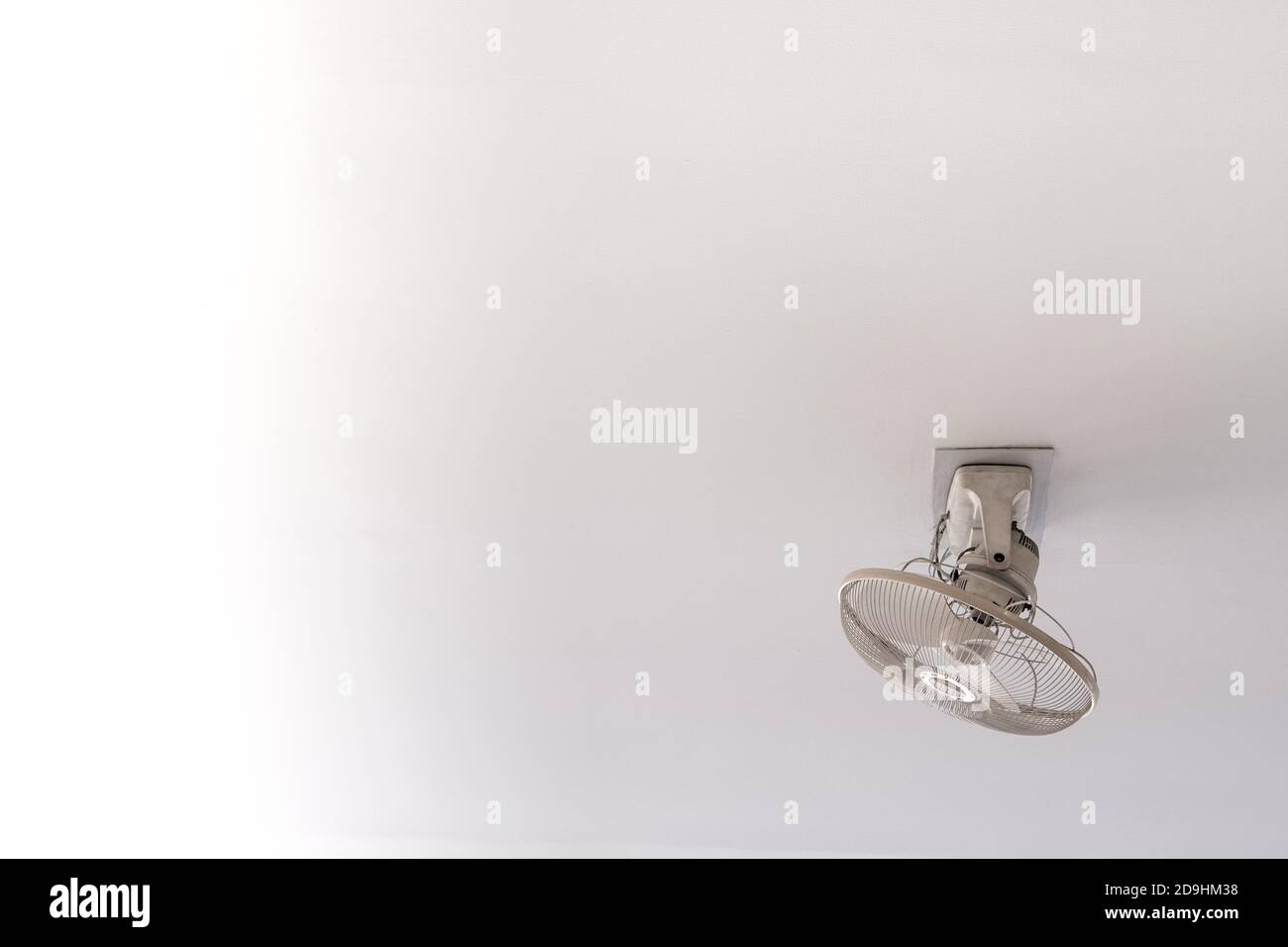 White Orbit ceiling fan on the ceiling of white room Stock Photo - Alamy