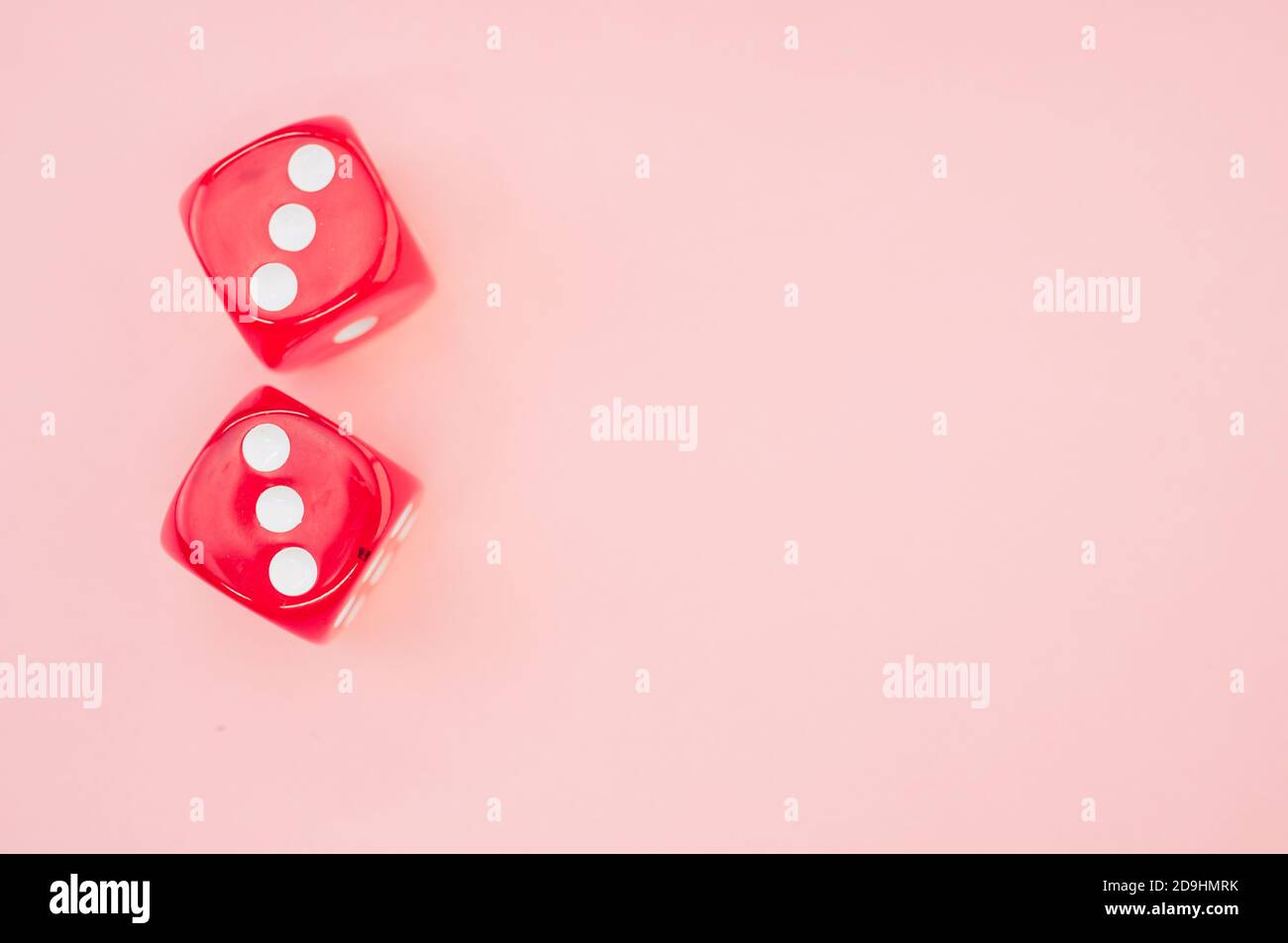 Top view shot of playing dice on an isolated pink background Stock ...
