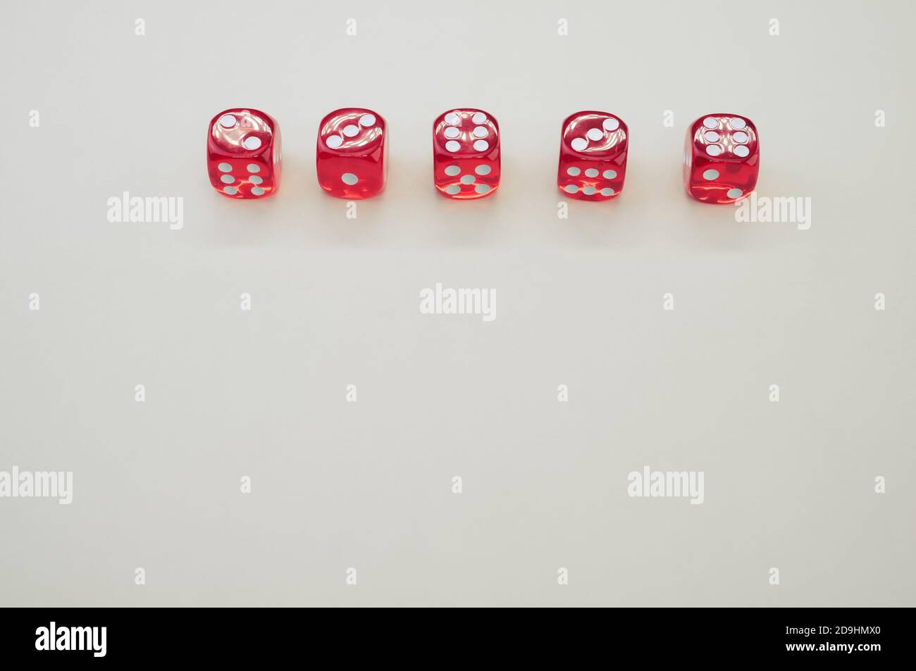 Closeup of red rolling dice on a white background Stock Photo - Alamy