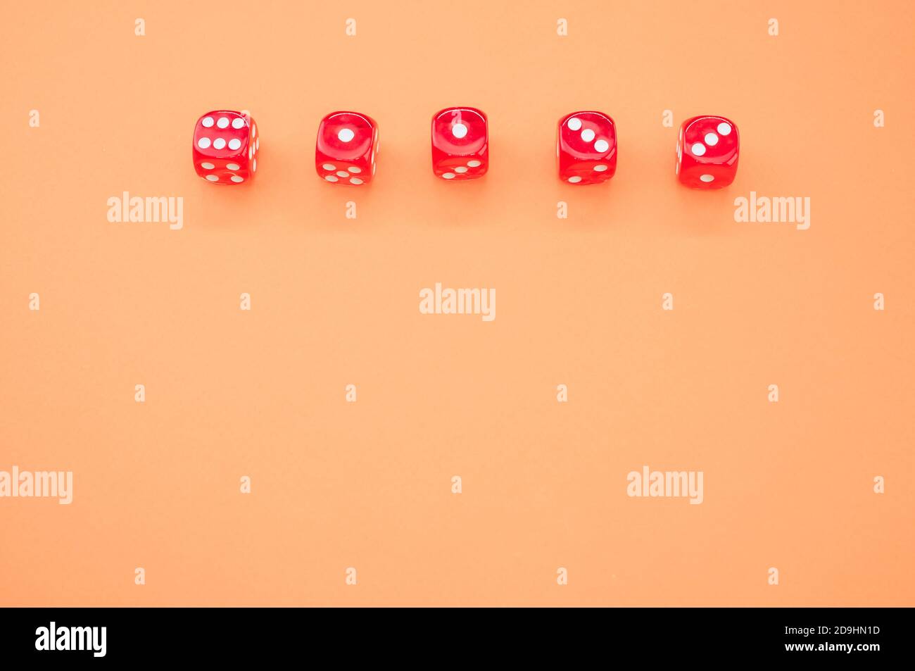 High angle shot of playing dice on an isolated orange background Stock ...