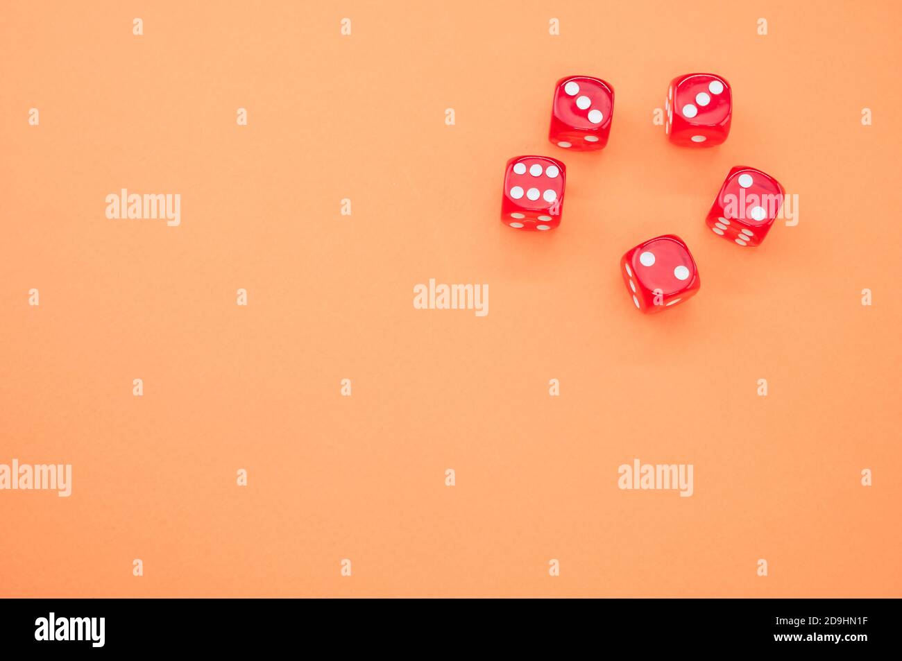 Top view shot of playing dice on an isolated orange background Stock ...