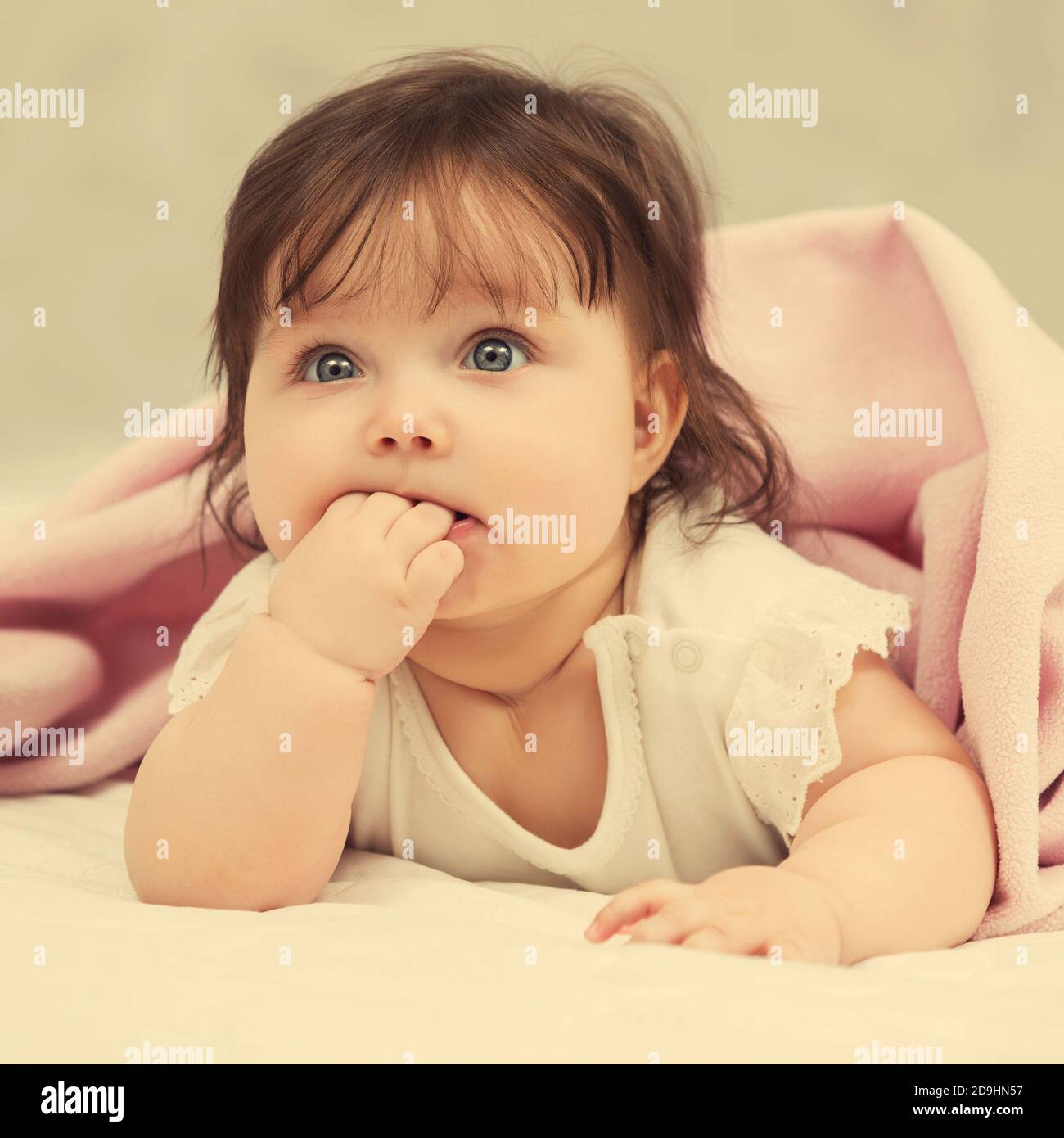 Happy six months old baby girl lying on blanket at home Stock Photo - Alamy