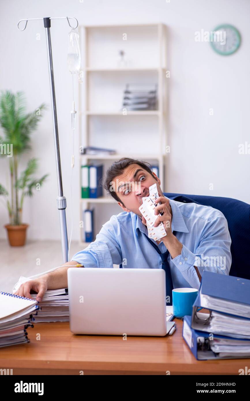 Male employee suffering at workplace Stock Photo - Alamy