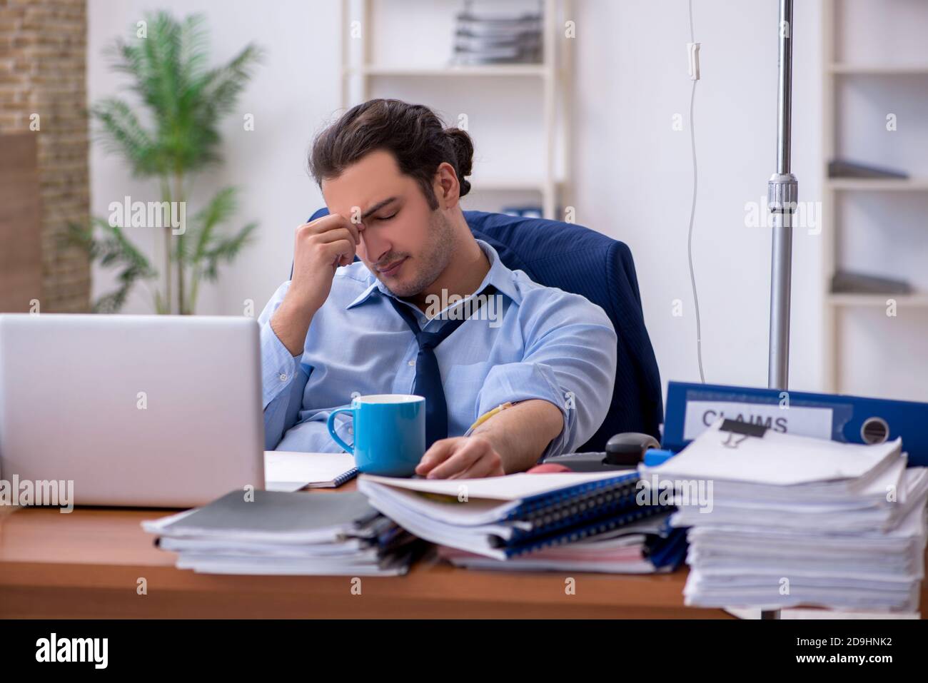 Male employee suffering at workplace Stock Photo - Alamy