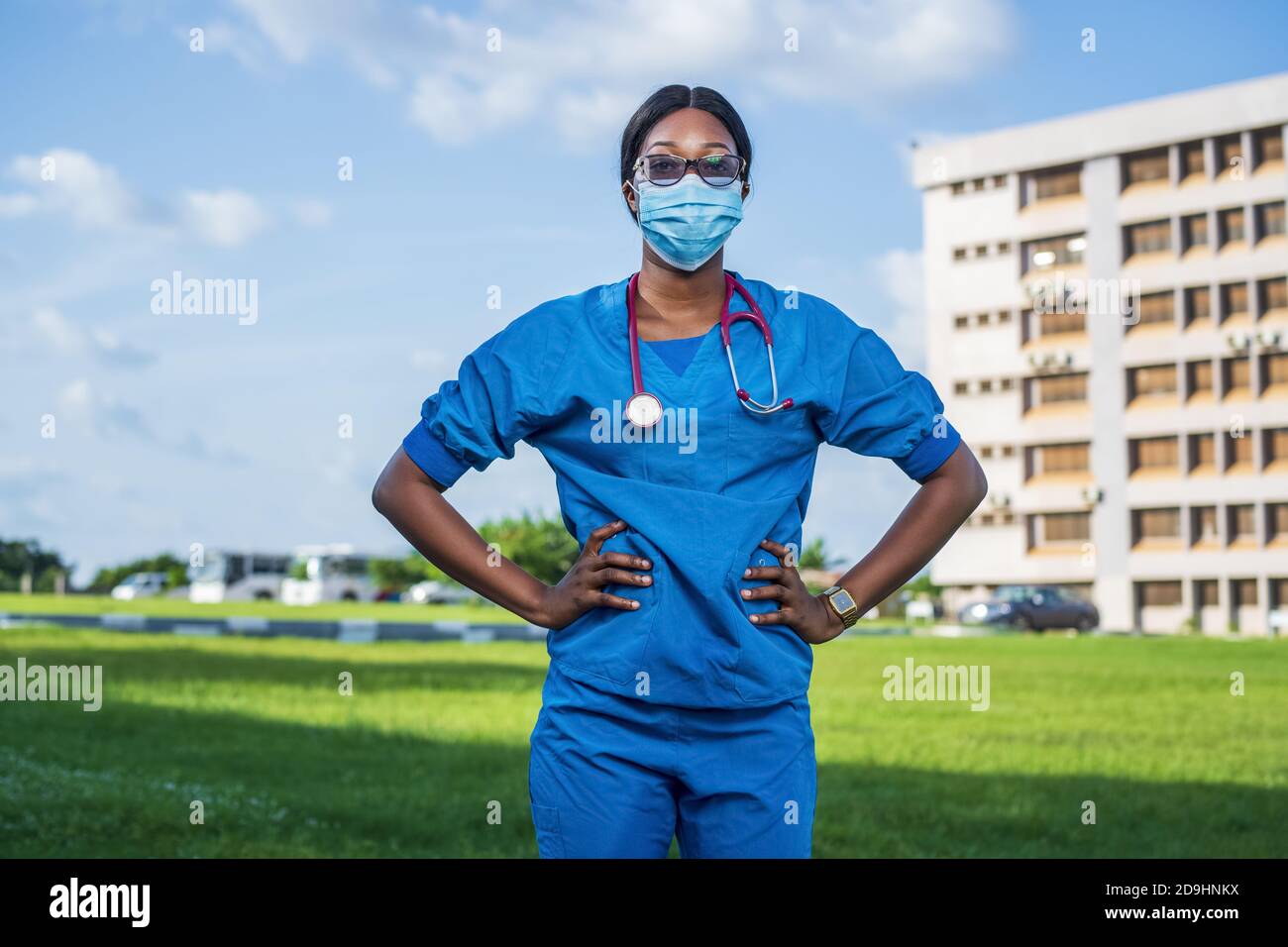 African-American nurse in a medical uniform and a mask in front of a ...
