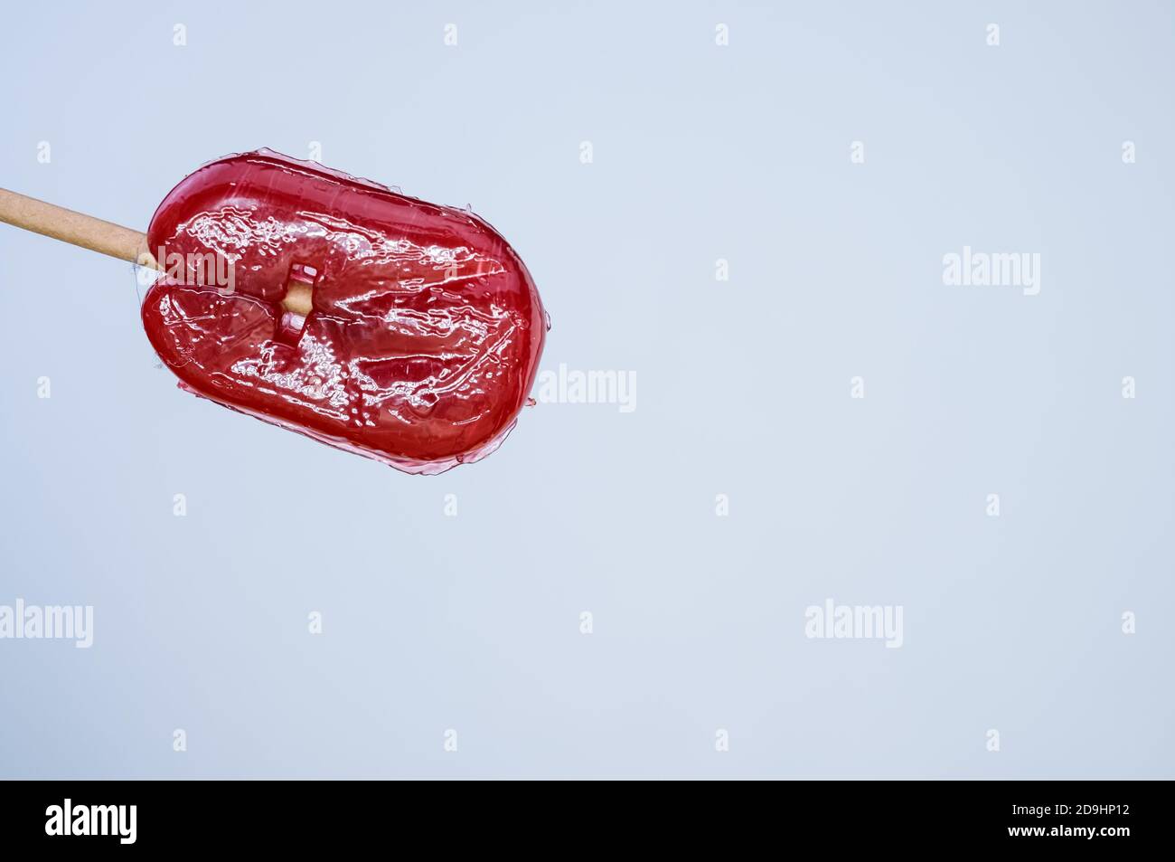 Closeup shot of red flavored lollipop isolated on white background ...