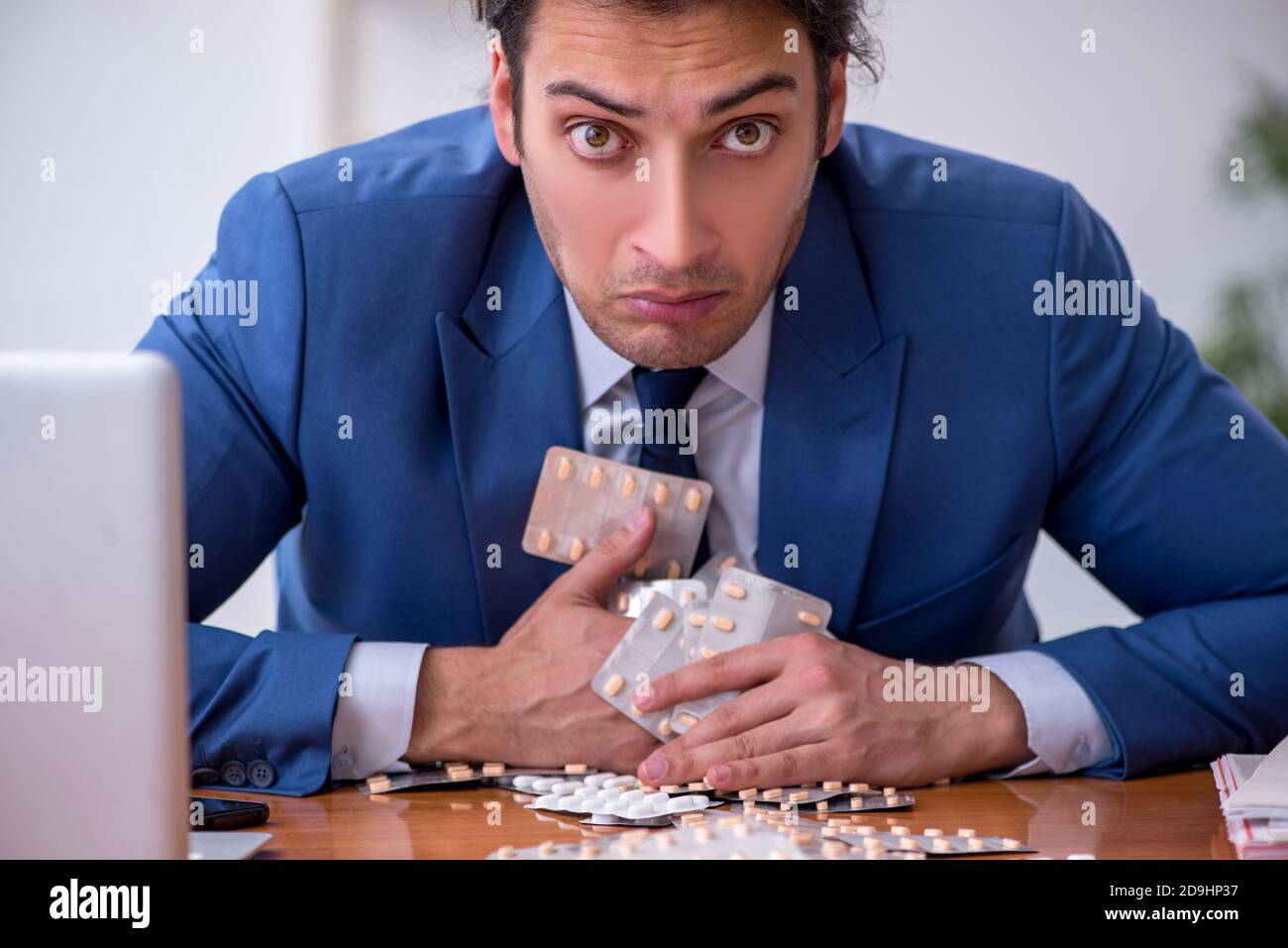 Sick male employee suffering at workplace Stock Photo - Alamy