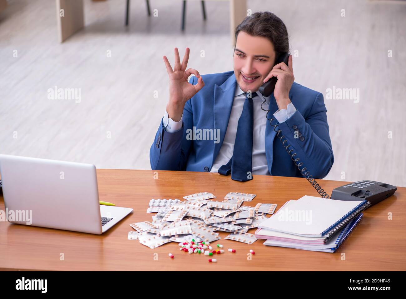 Sick male employee suffering at workplace Stock Photo - Alamy