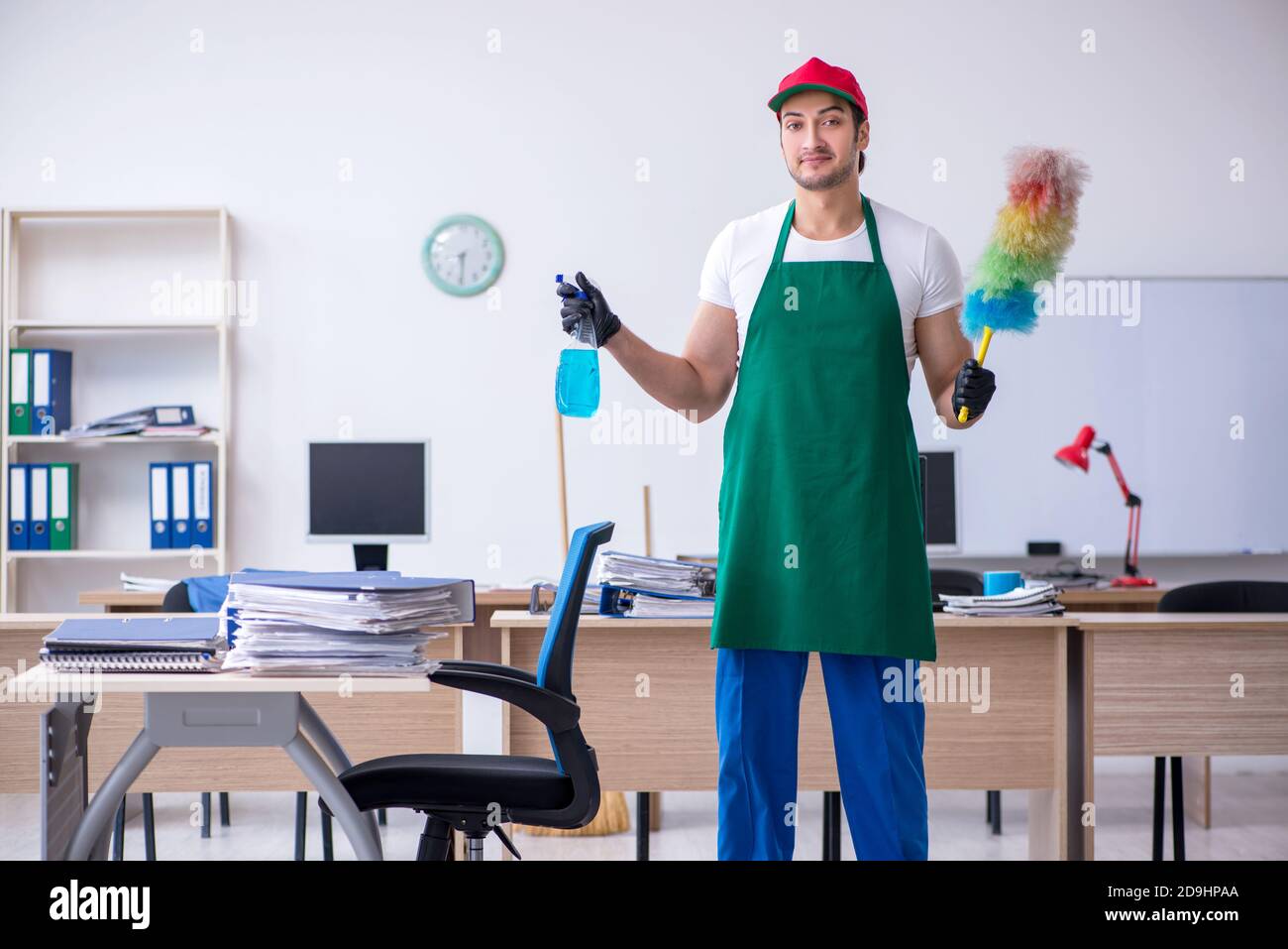 Young contractor cleaning the office Stock Photo - Alamy