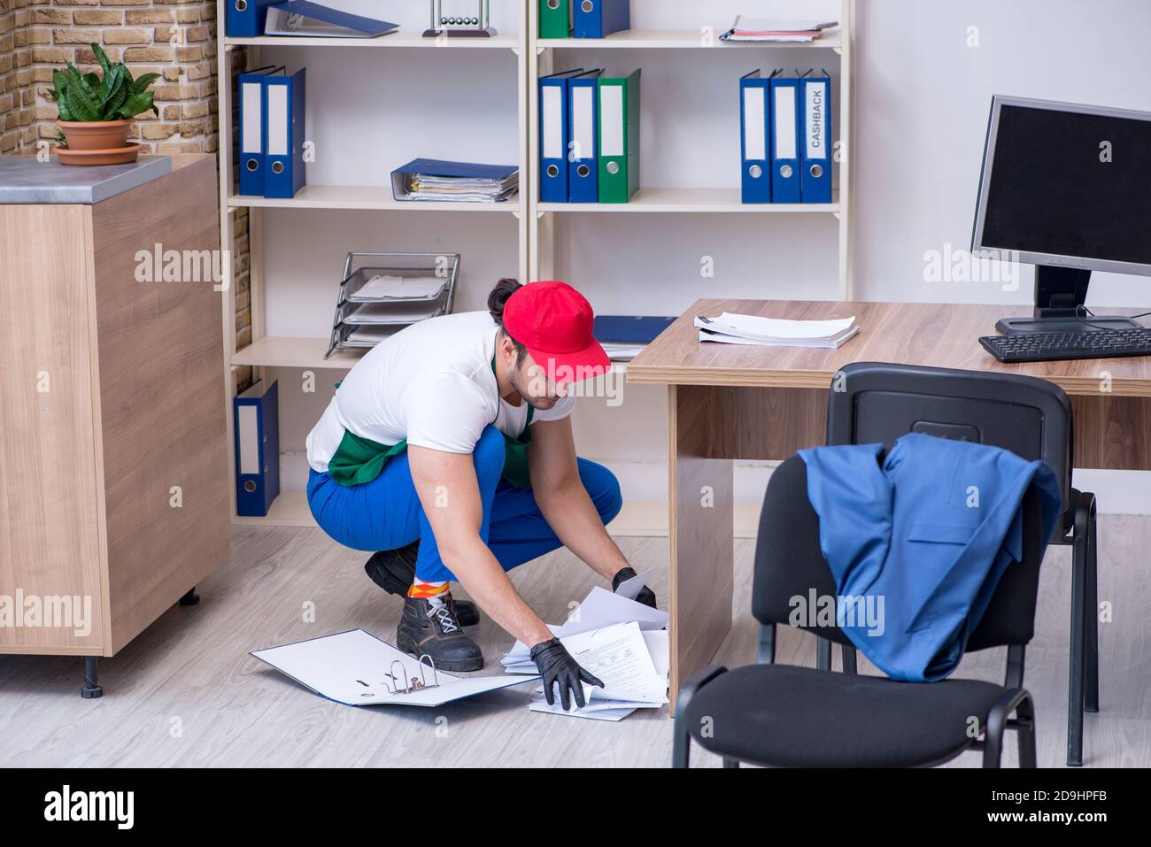 Young contractor cleaning the office Stock Photo - Alamy