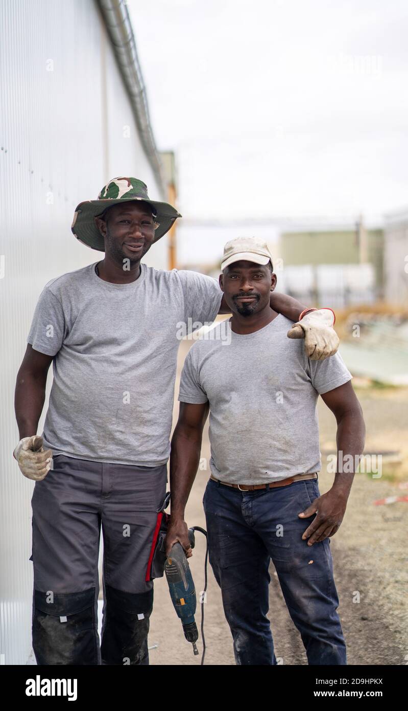Afro-American builders having a break Stock Photo - Alamy