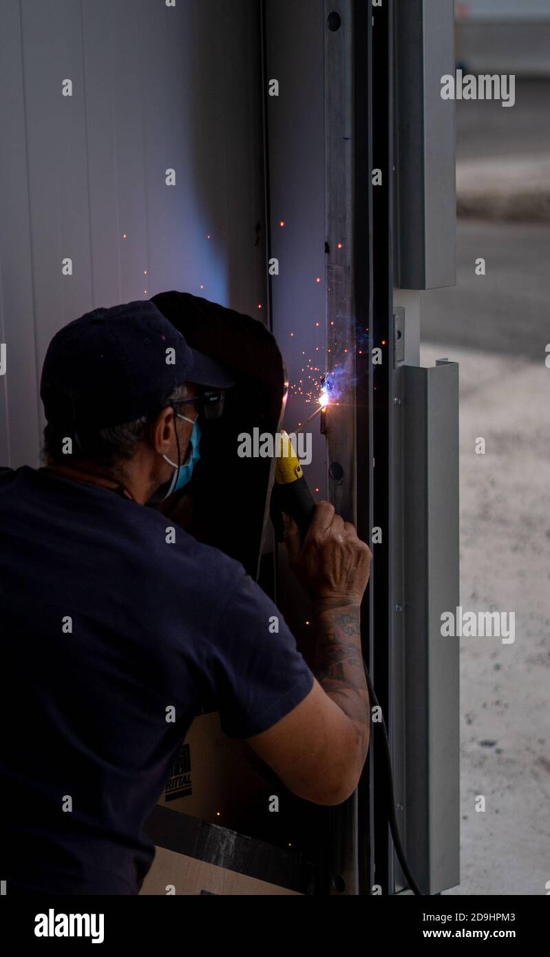 Welder wearing a face mask while working Stock Photo - Alamy