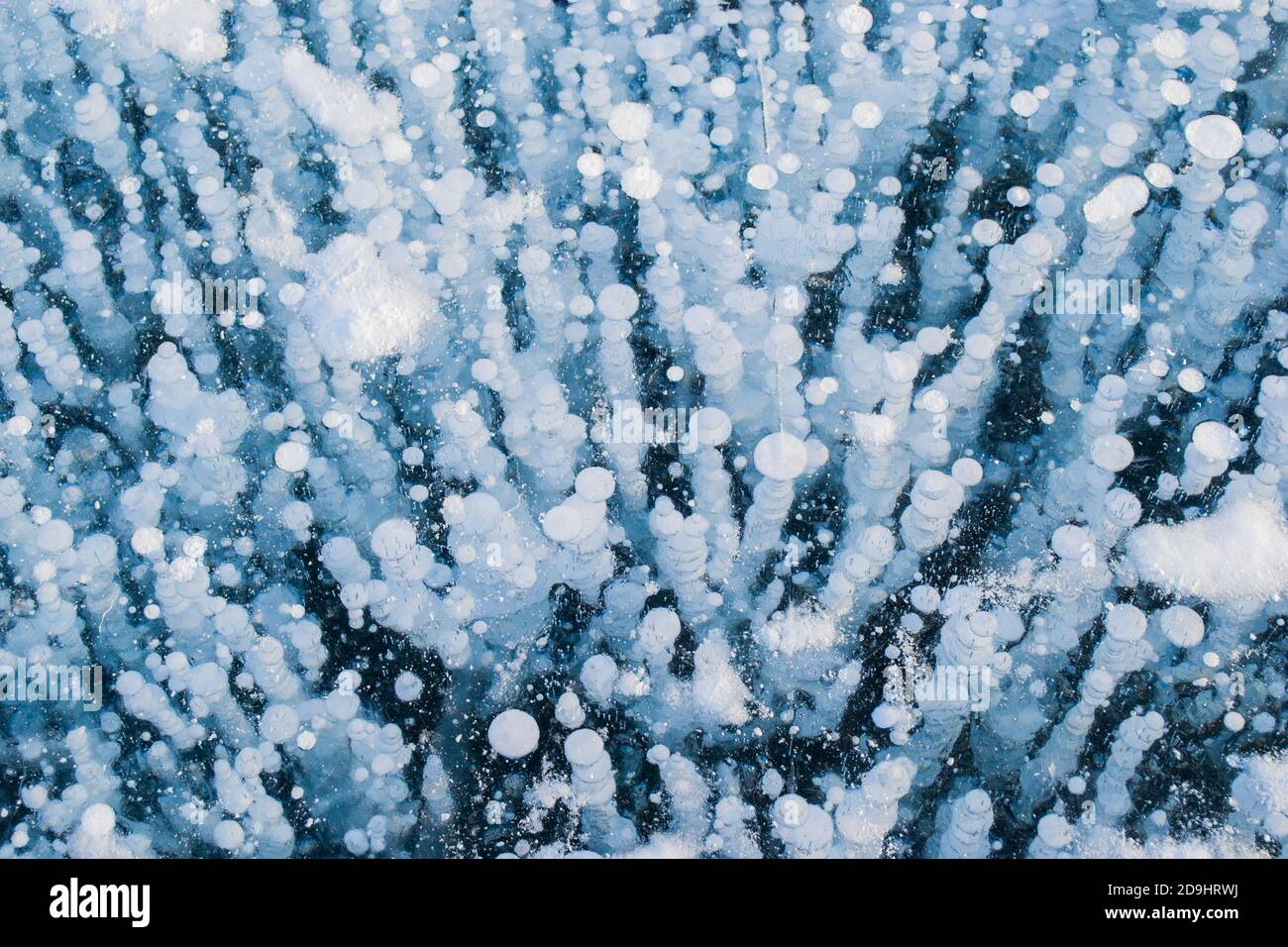 Beautiful transparent blue ice with frozen white methane bubbles ...