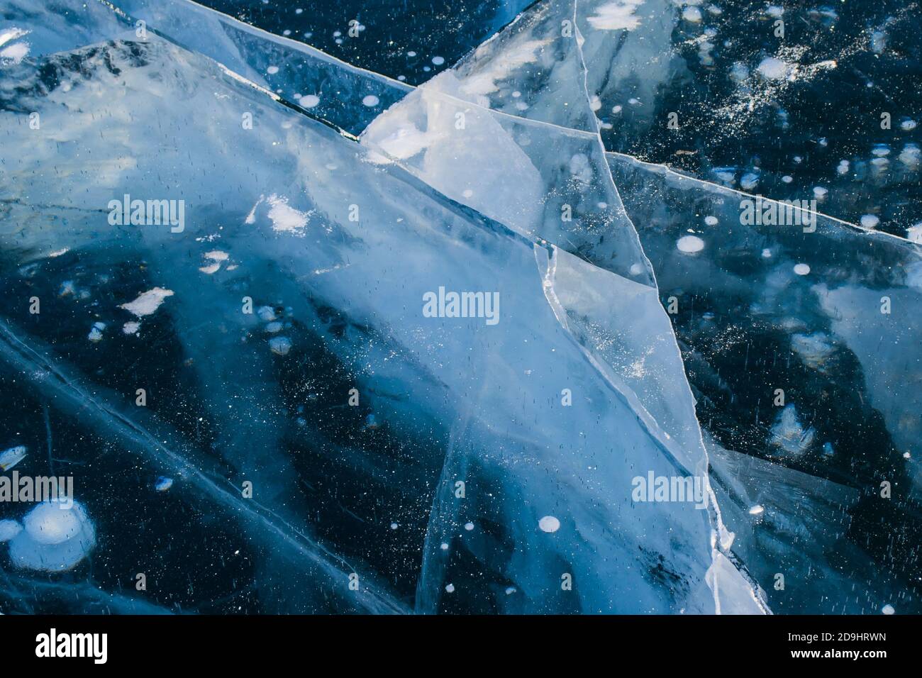 Winter Baikal, covered with a thick layer of transparent ice with ...