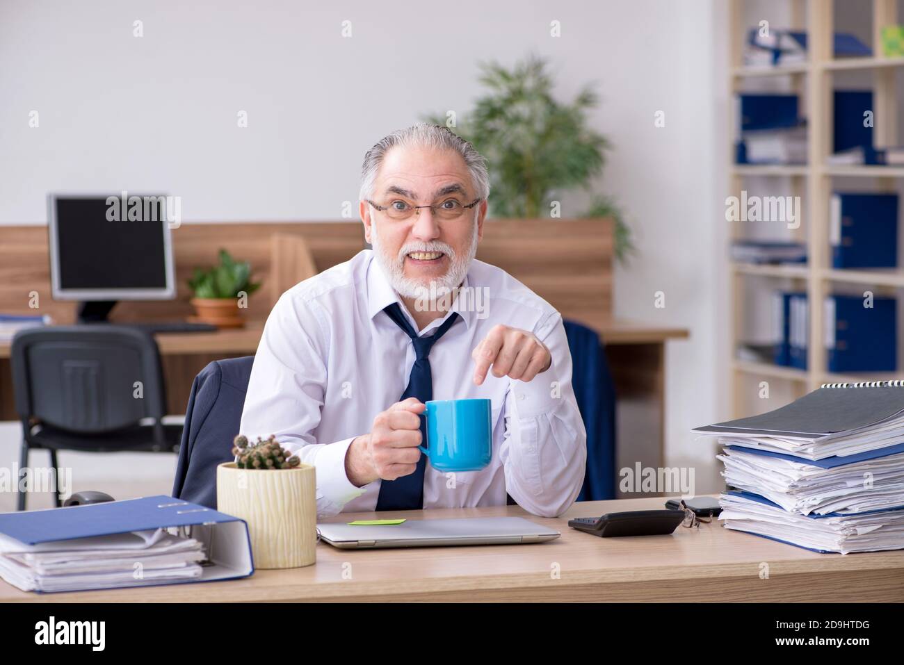 Old employee working in the office Stock Photo - Alamy