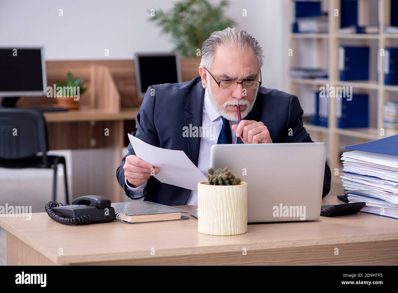 Old employee working in the office Stock Photo - Alamy