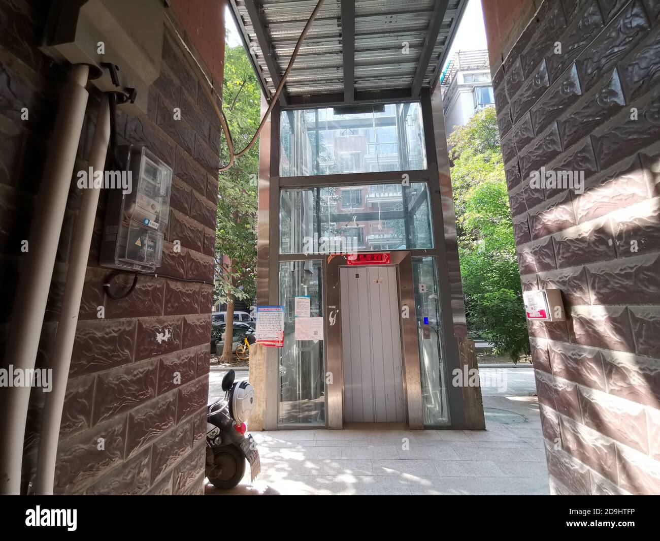 An elevator is built on the outside of an old apartment building to ...