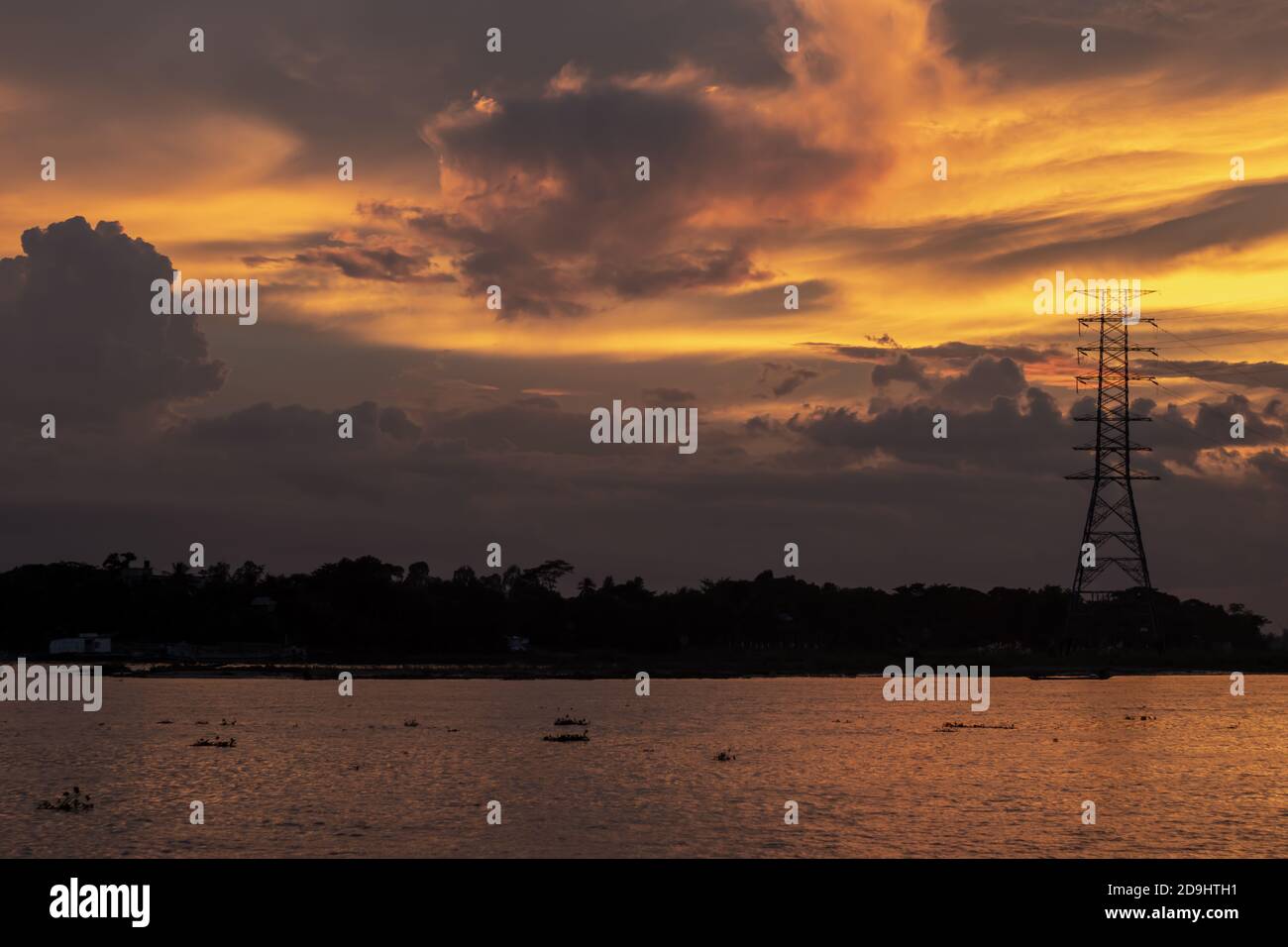 Beautiful cloudy yellow sunset sky above the river Stock Photo - Alamy