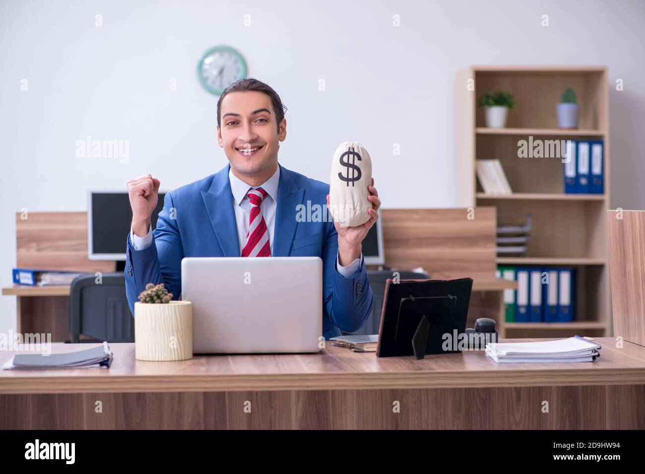 Young employee in remuneration concept Stock Photo - Alamy