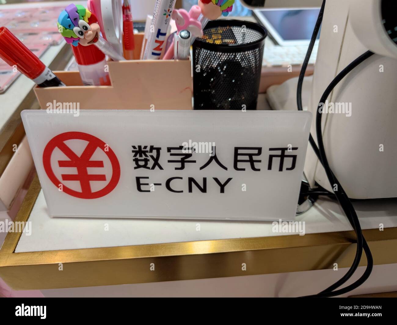 An E-CNY payment sign is put up on a desk in a store in the Luohu ...