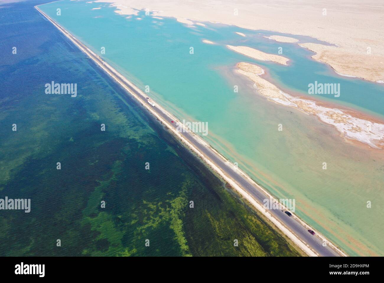 Aerial view of the °most beautiful highway over lake" in Dachaidan Town ...