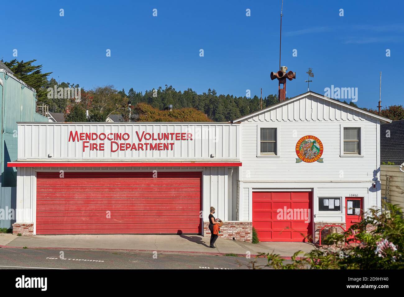 White and red painted historic fire station on a street at Mendocino ...
