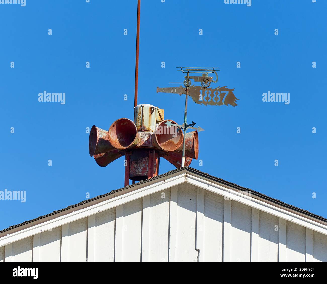 Rusty alarm sirens and metal wind sign on the rooftop of a fire ...