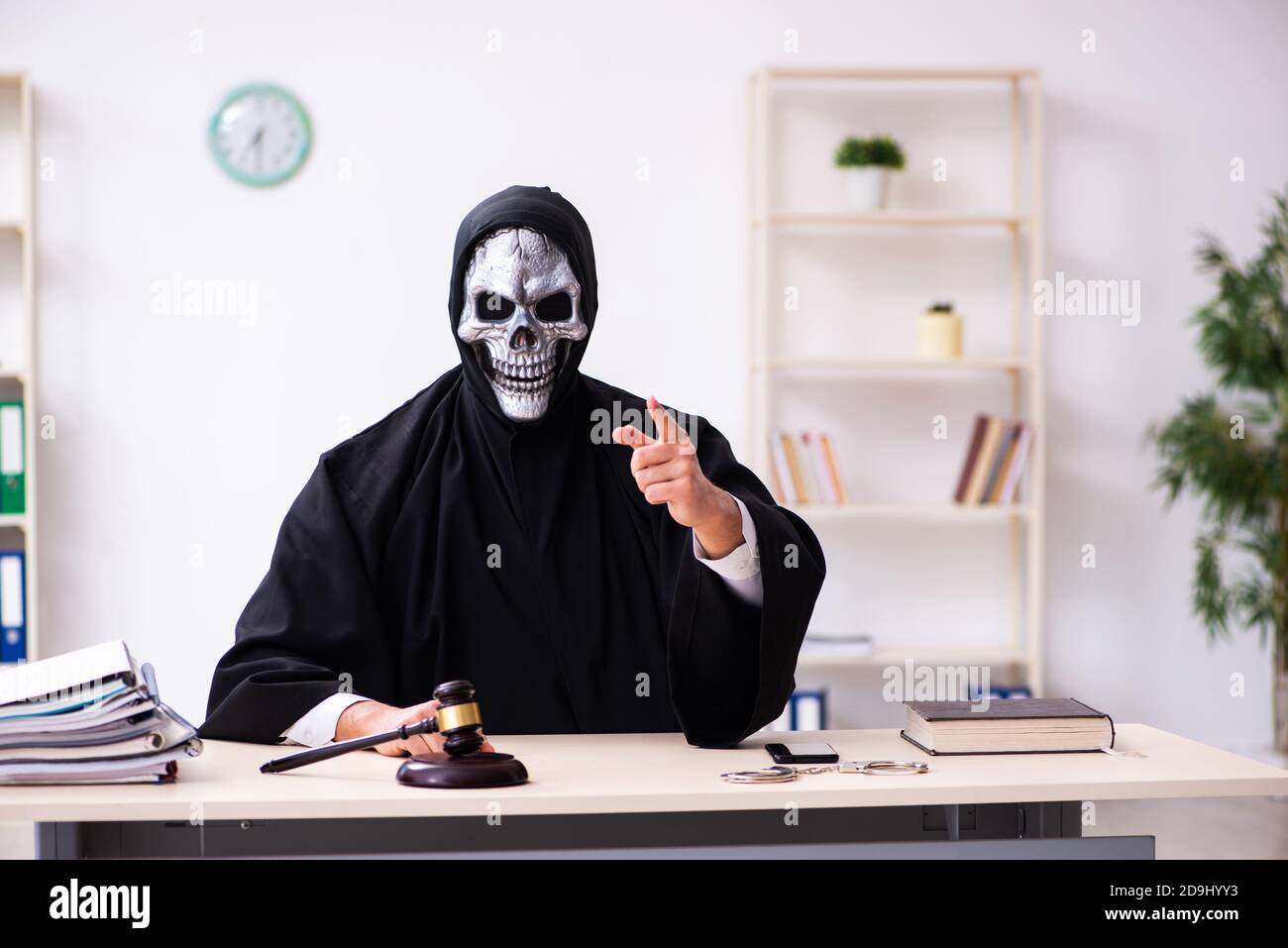 Devil judge working in the courthouse Stock Photo - Alamy