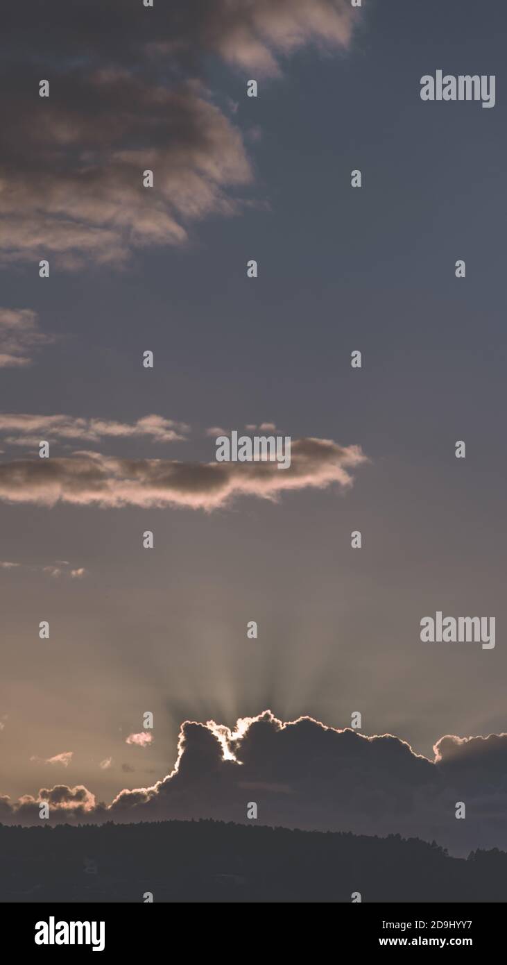 Vertical panoramic shot of a beautiful dramatic cloudscape with setting ...