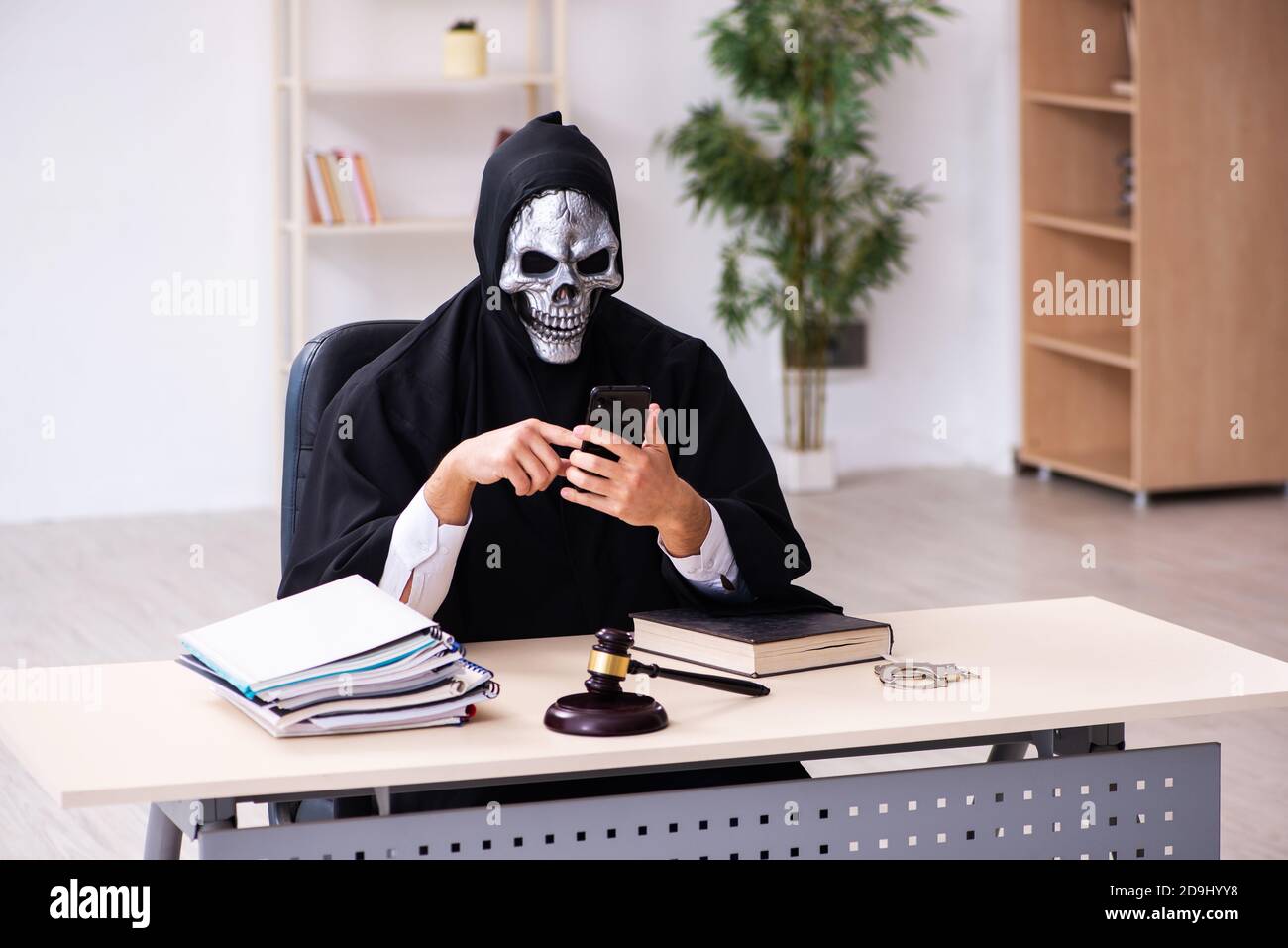 Devil judge working in the courthouse Stock Photo - Alamy